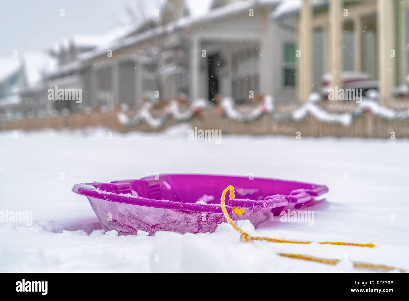 Close up view of a purple sled against frosty snow. Close up view of a ...