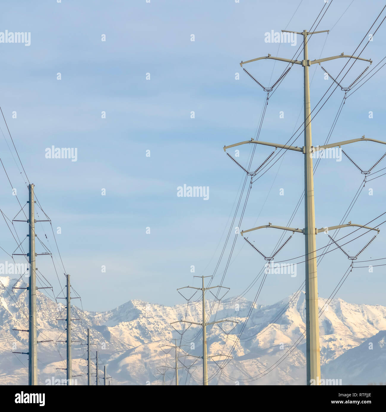 Power lines against snow capped Mount Timpanogos. Overhead power lines ...