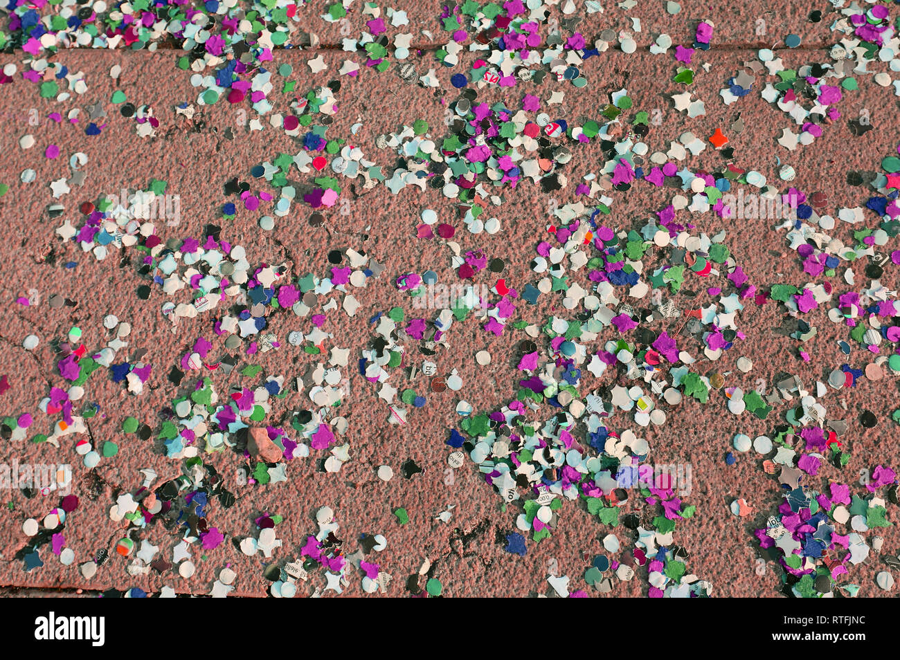 many colorful confetti thrown on the street by children during Carnival ...