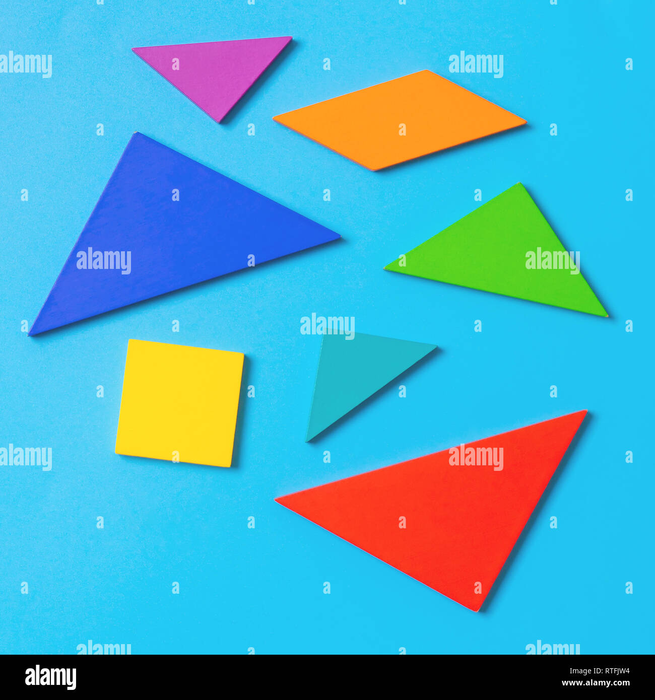 Colorful wooden tangram puzzle toy on blue Stock Photo - Alamy