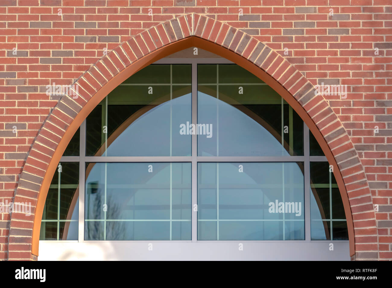 Reflective arched glass window of a church. Close up view of the ...