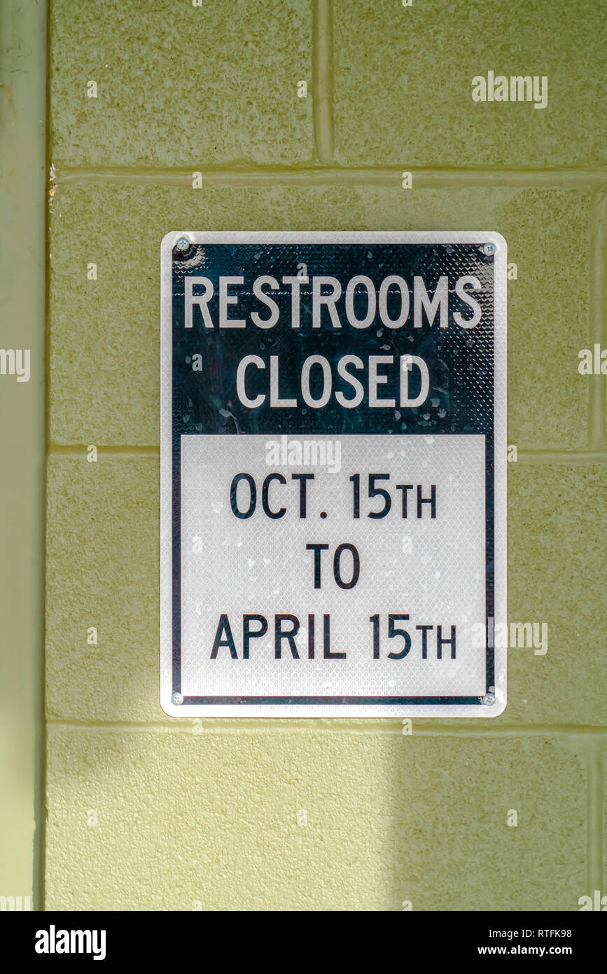 Restrooms Closed sign on a park's public restroom. Restrooms Closed ...