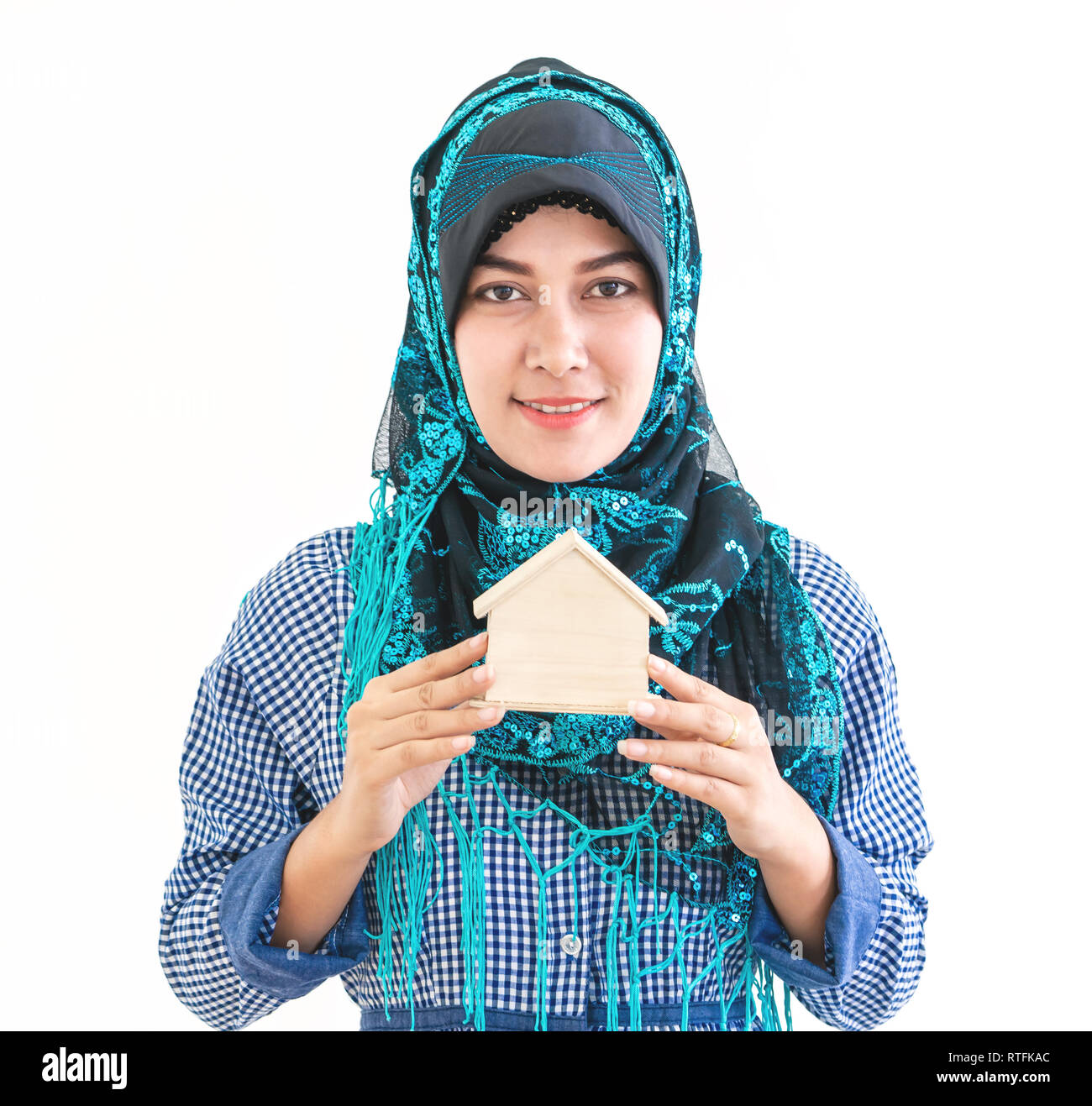 Muslim Woman is holding a house model for housing concept Stock Photo ...