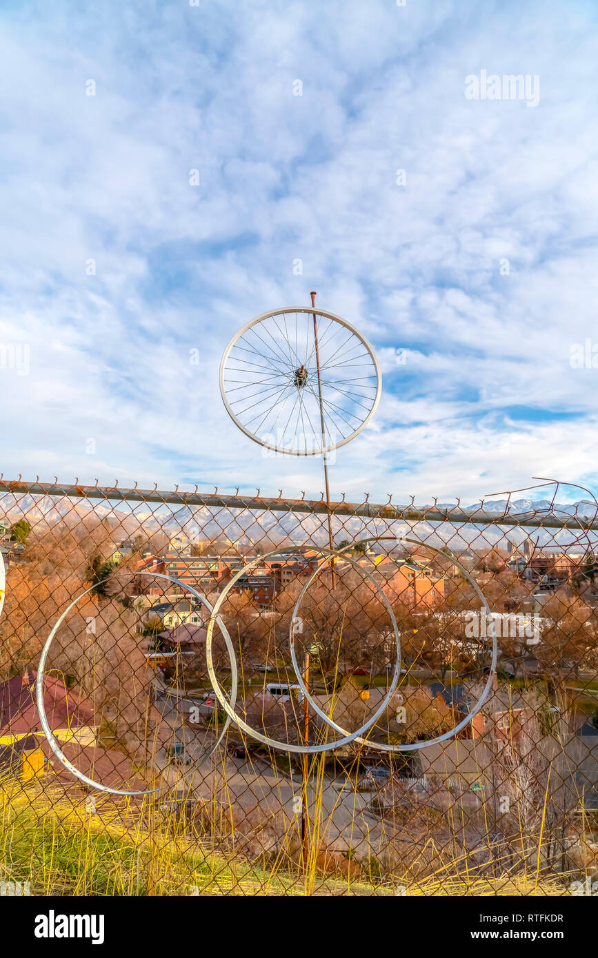 Rusty chain link fence with bicycle wheel rims. Old bicycle wheel rims ...
