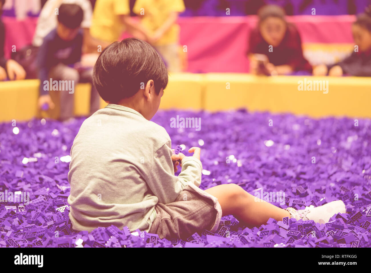 boy is playing with purple educational toy block Stock Photo - Alamy