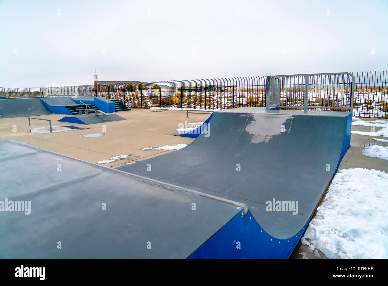 Skateboard ramps with melting snow on the ground. Skateboard ramps on a ...