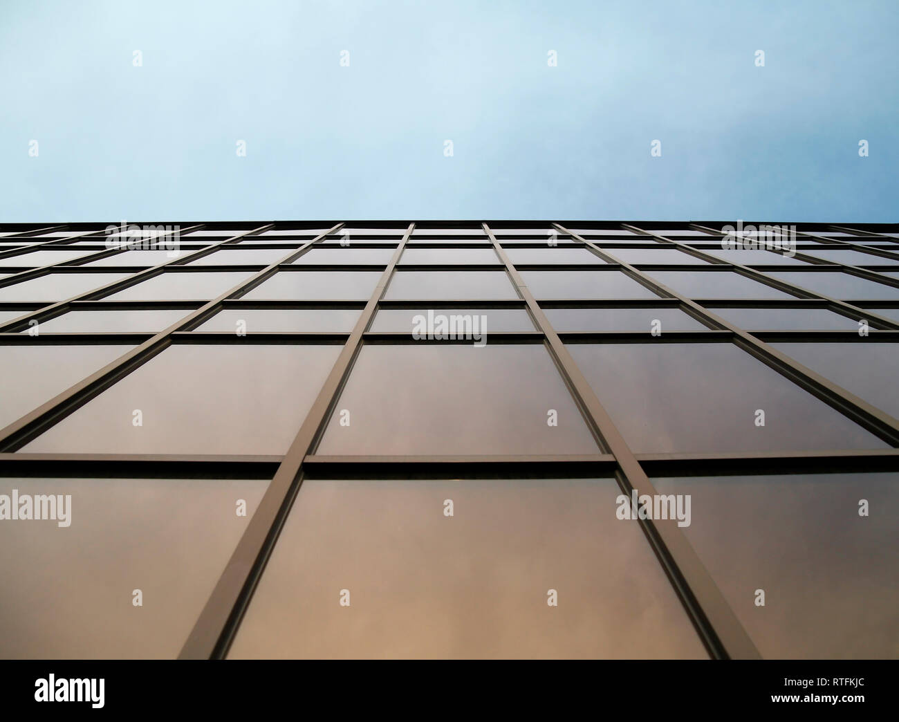 glass wall of modern trade center over the blue sky Stock Photo - Alamy