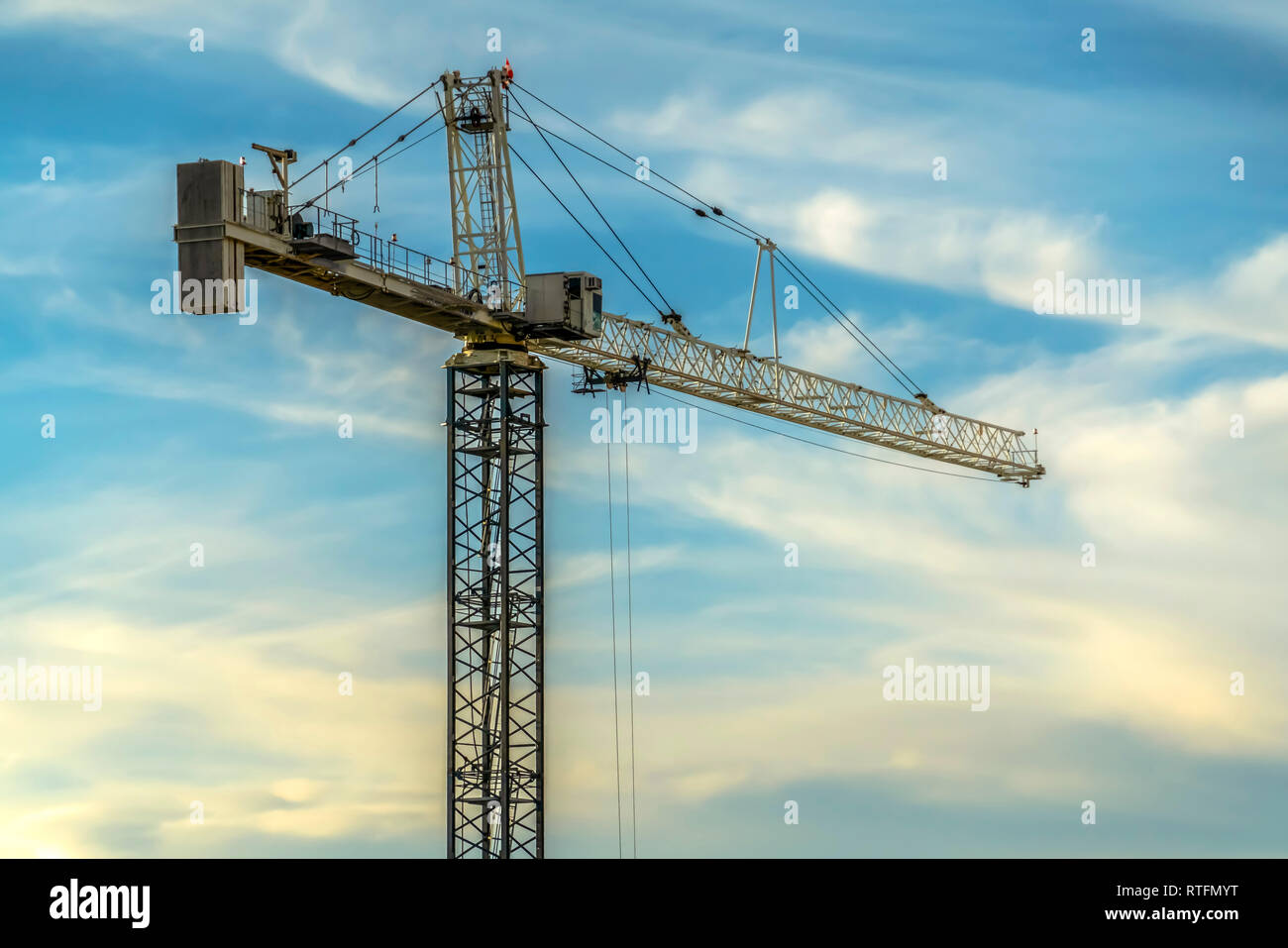 Tower crane at a construction site against sky. Close up view of an ...