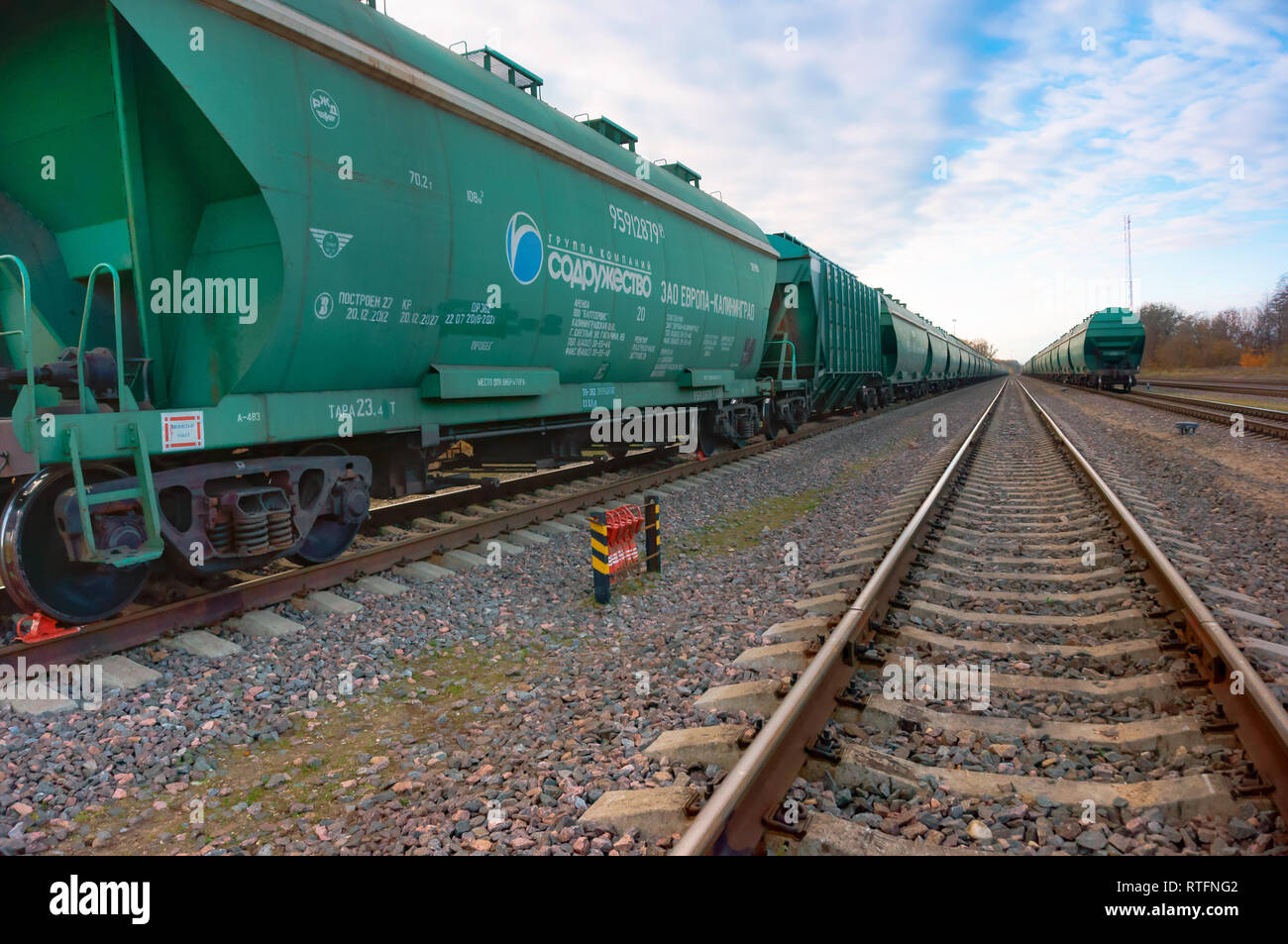 a freight train is green, the cars of a freight train standing on the ...
