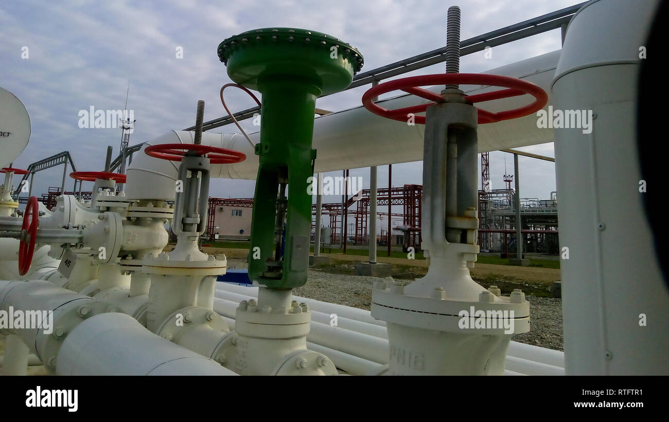 Green pneumatic valve on the pipeline. The equipment of the oil plant ...