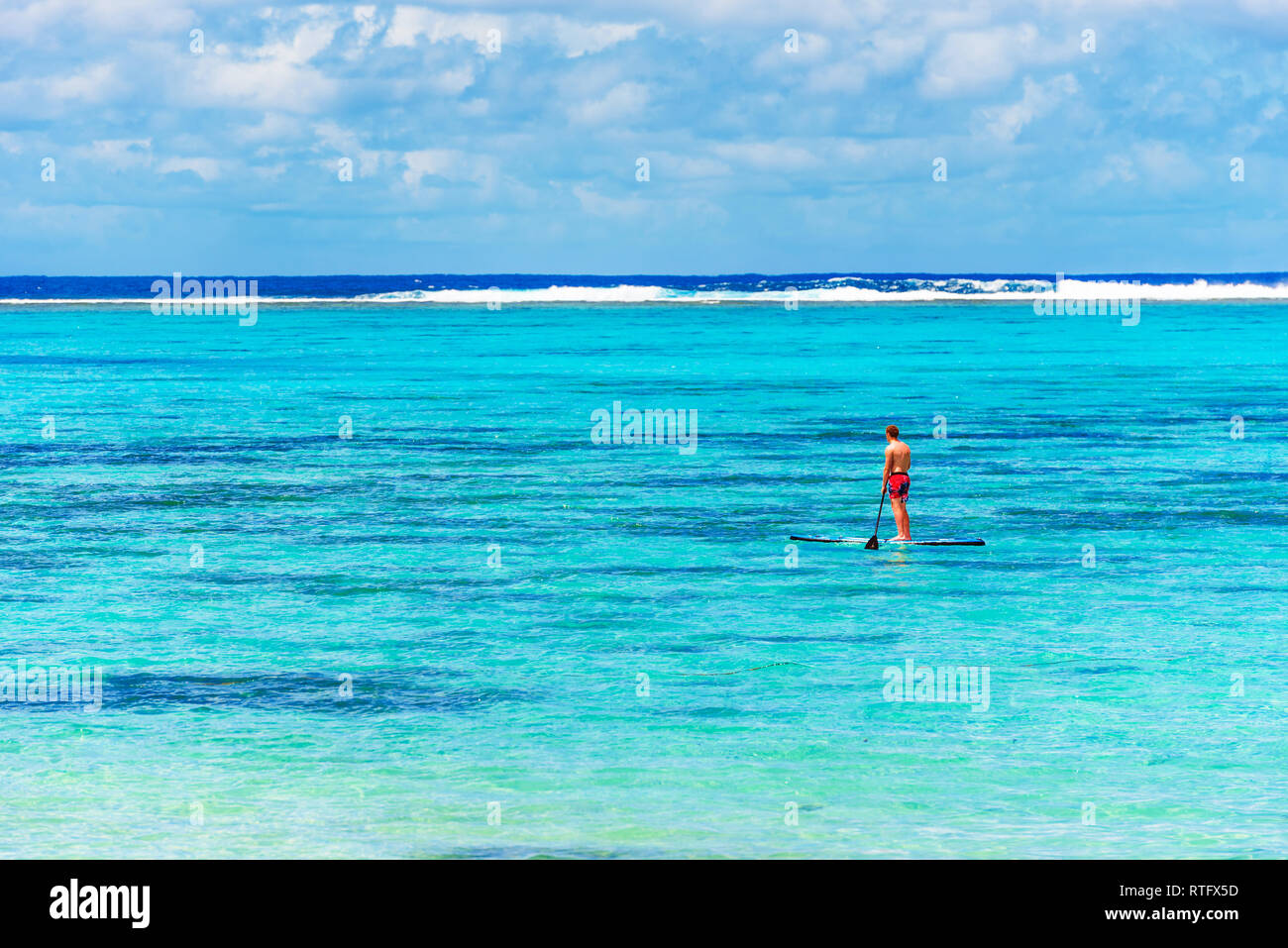 Man paddle on surfboards in the ocean, Cook Islands, South Pacific ...