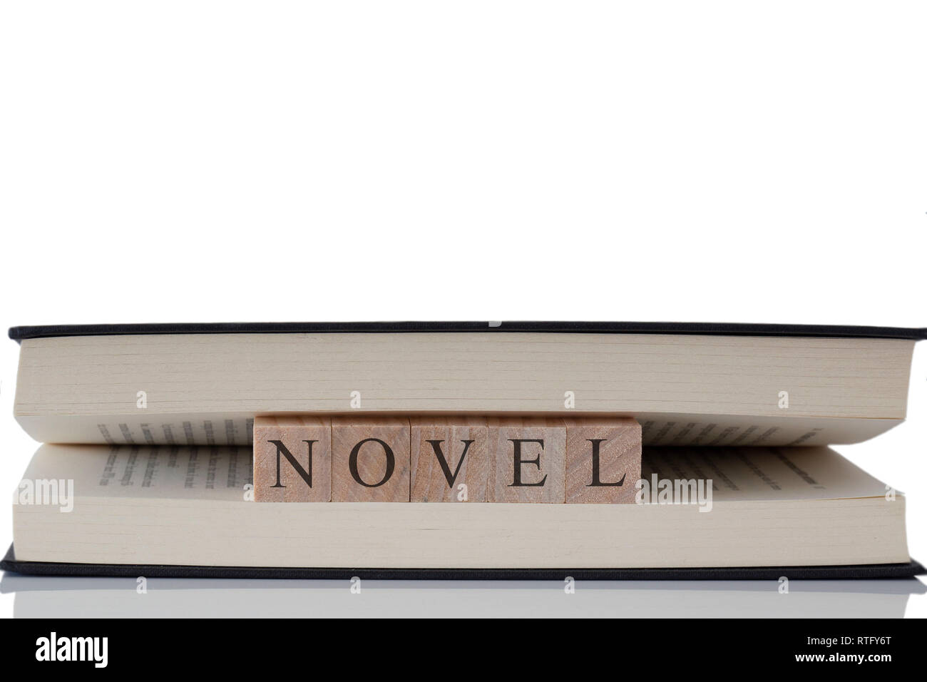 Novel written on wooden blocks inside a book isolated on a white ...