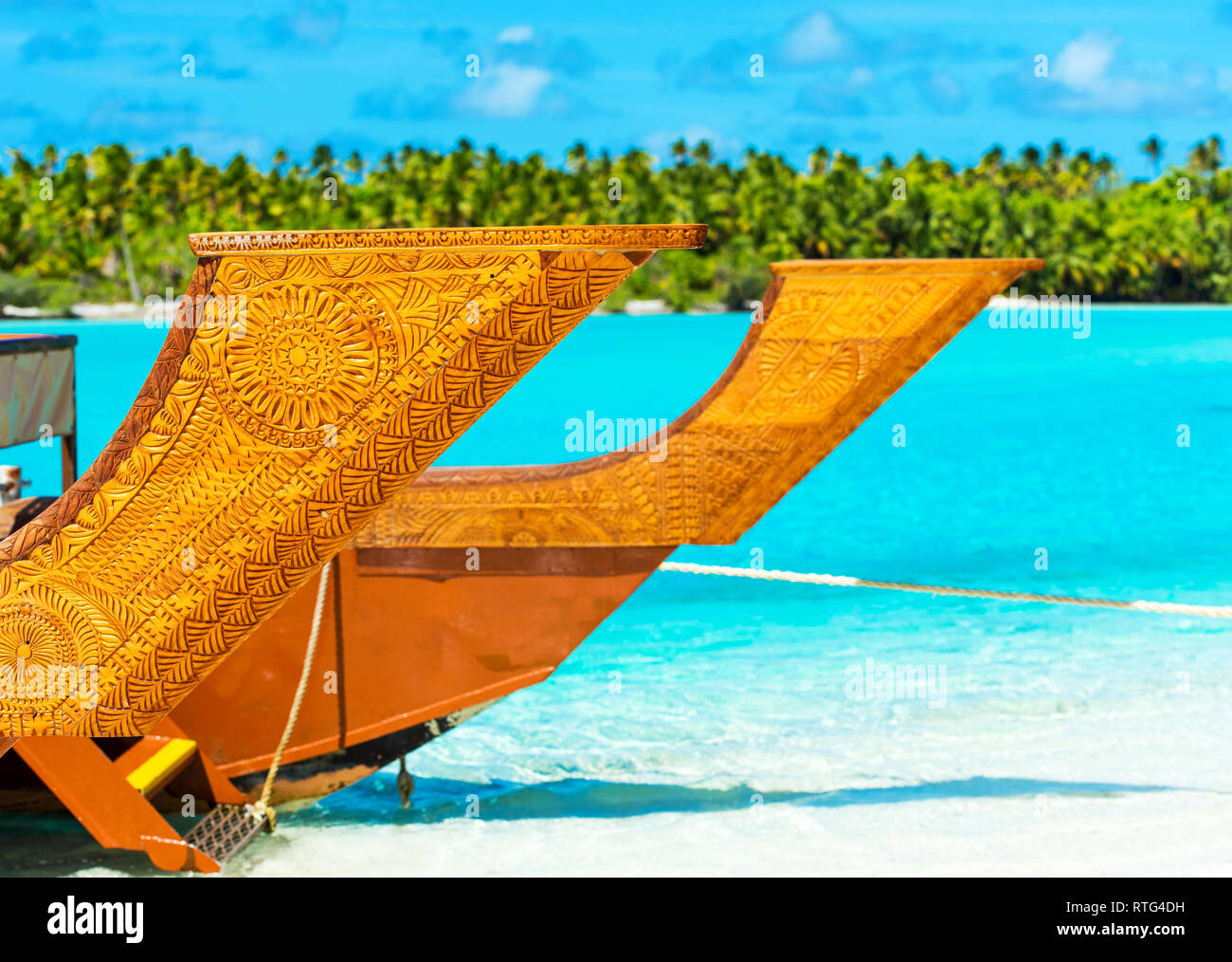 Wooden carved boat on a sandy beach in Aitutaki island, Cook Islands ...