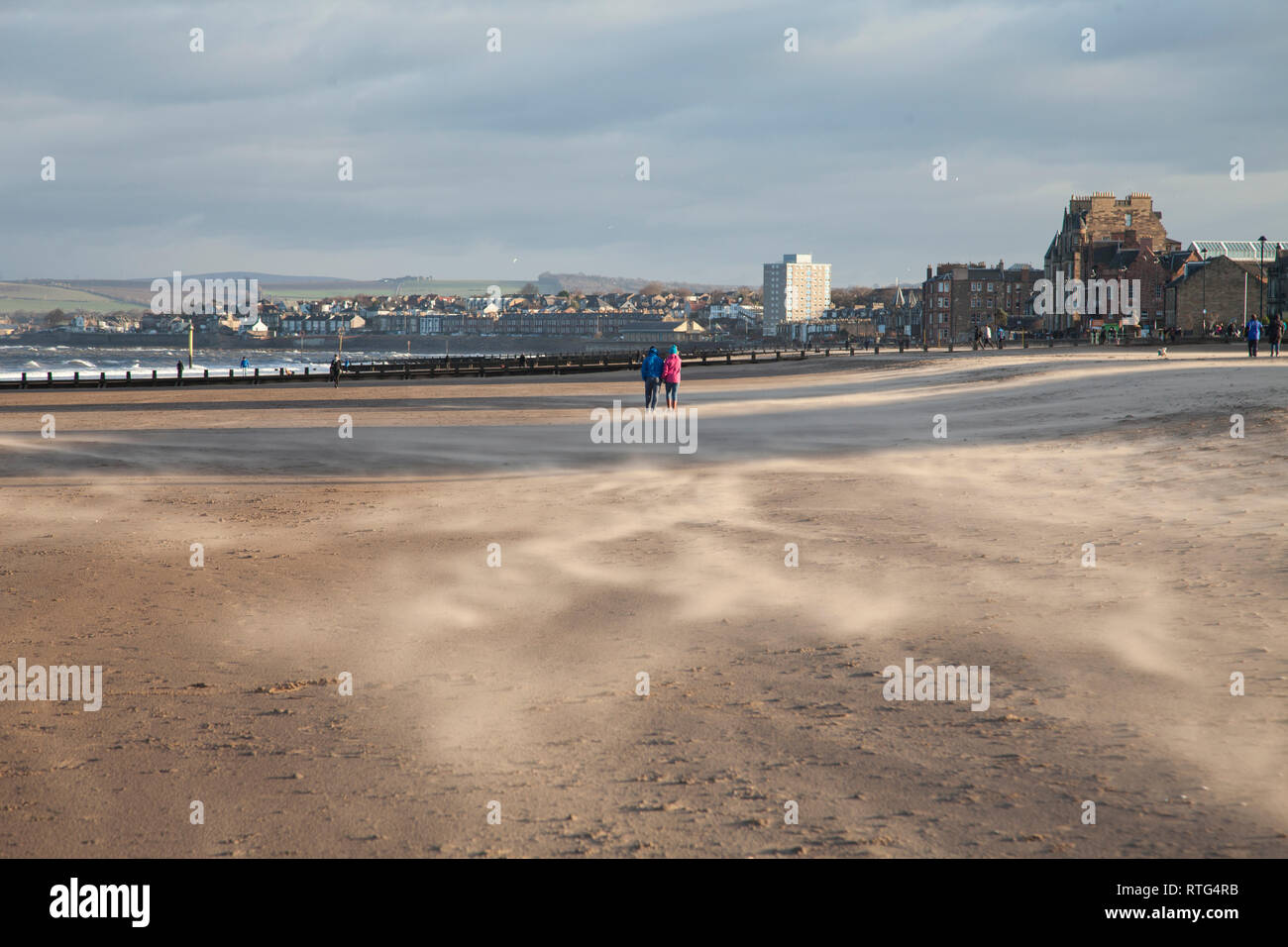 Sunny and very windy weather on a bright day on Portobello beach in ...