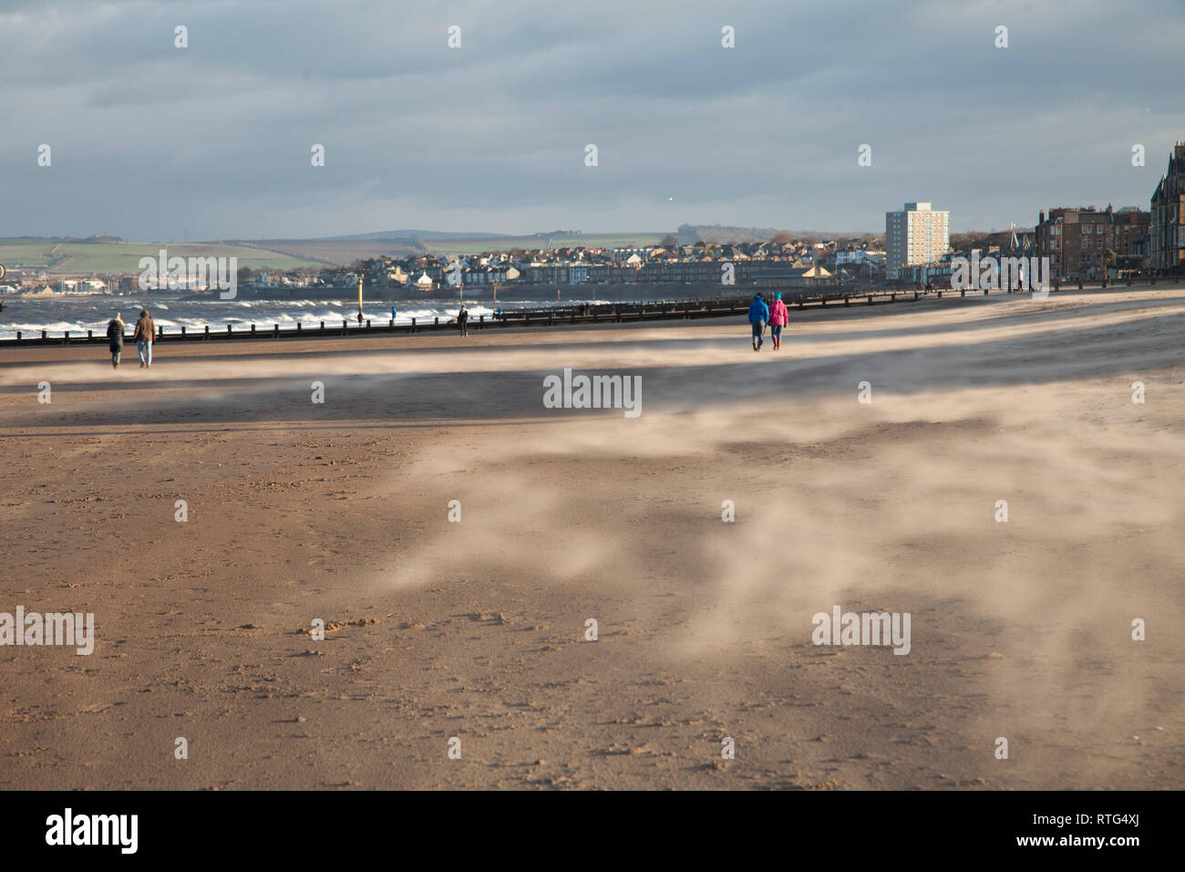 Sunny and very windy weather on a bright day on Portobello beach in ...