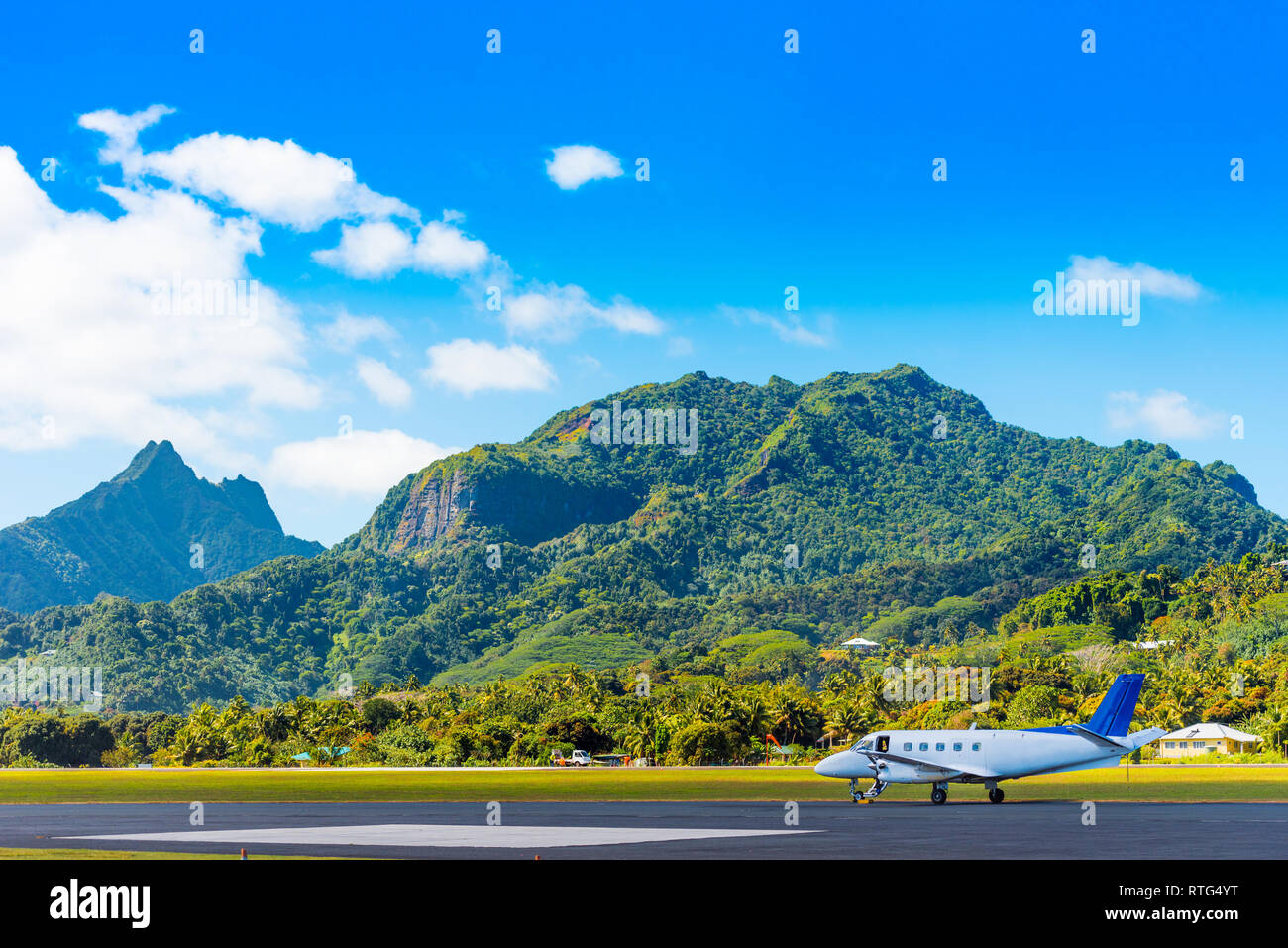 The plane at the airport on a background of mountain scenery, Aitutaki ...