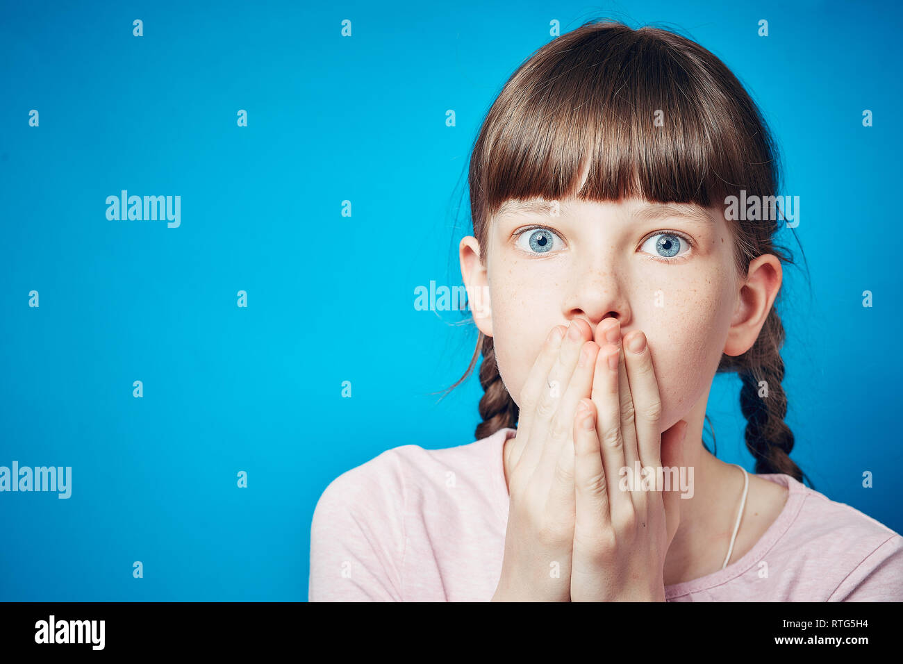 surprised astonished overwhelmed girl covering her mouth with hands ...