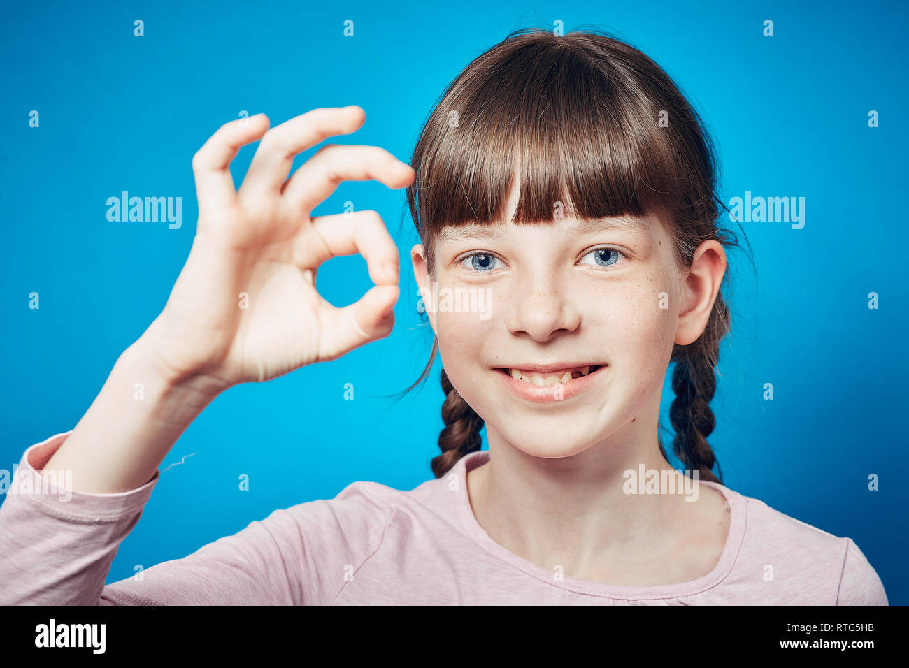 ok gesture. smiling adolescent girl. happy facial expression Stock ...
