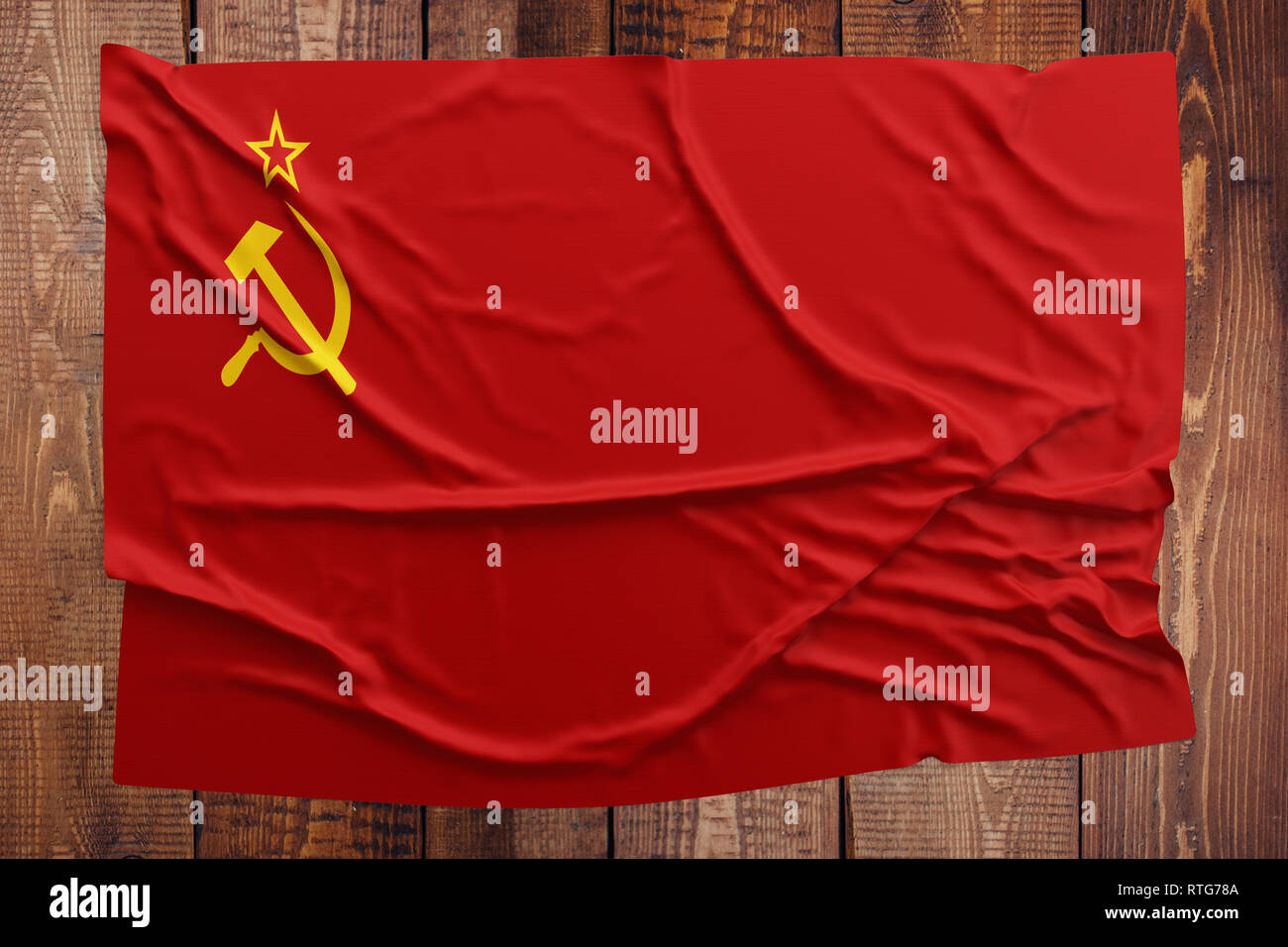 Flag of Soviet Union on a wooden table background. Wrinkled USSR flag ...