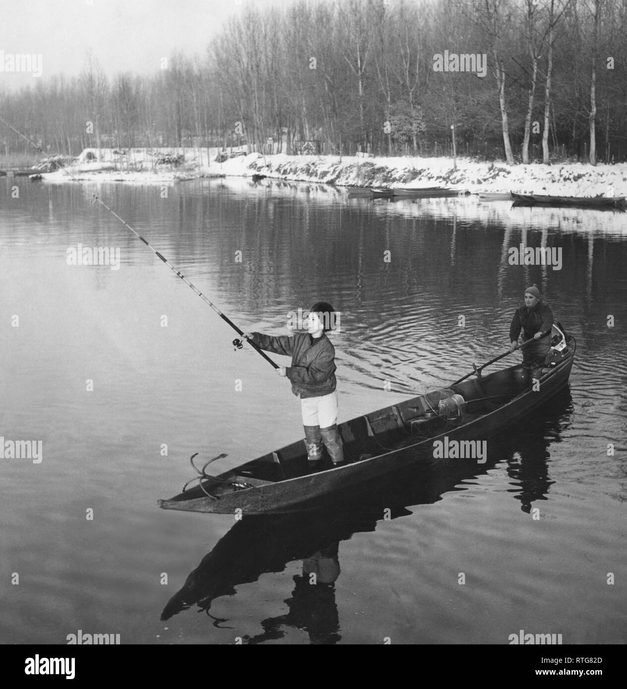 Two fisherman fishing rods Black and White Stock Photos & Images - Alamy