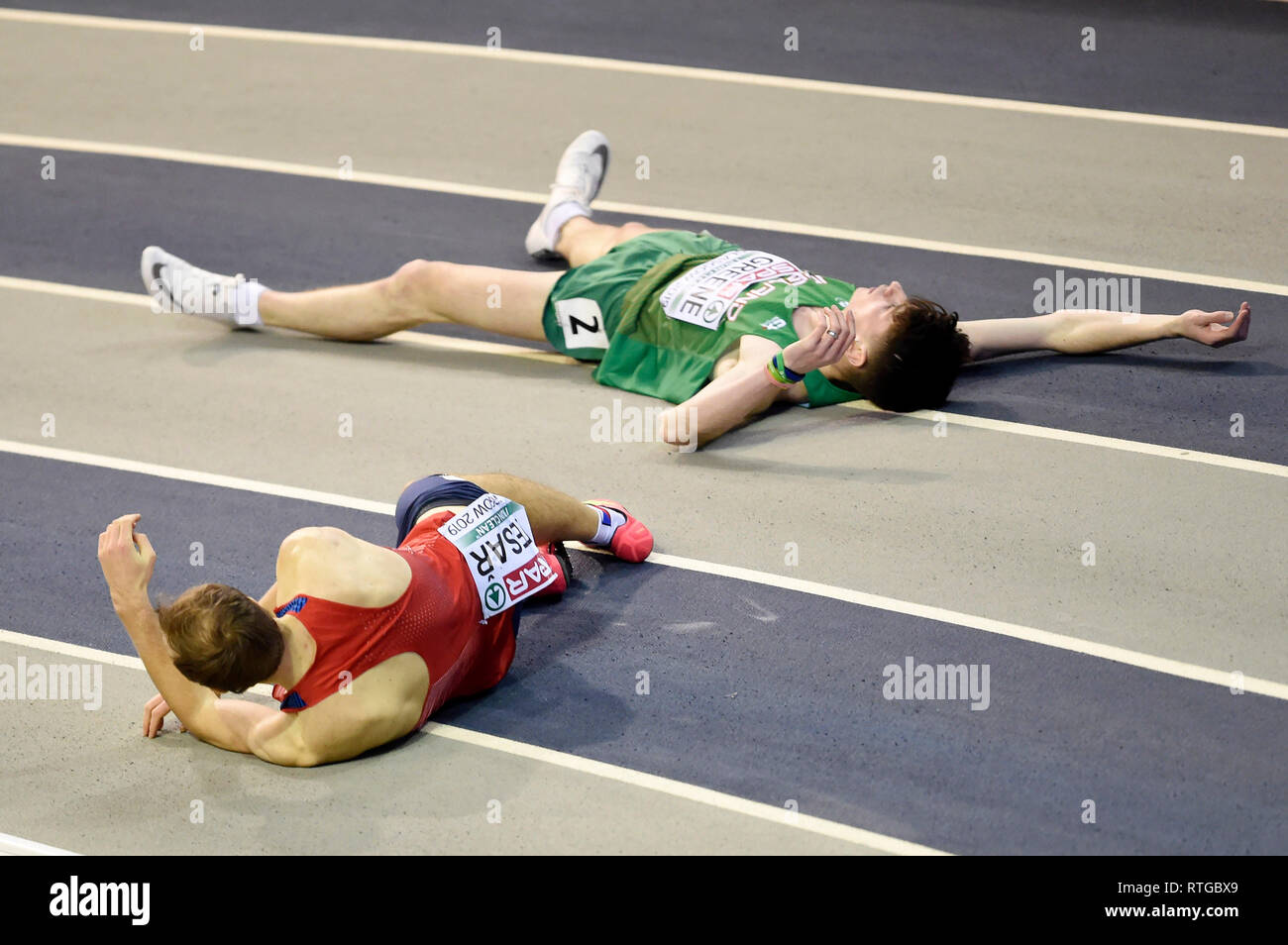 Czech Republic's Jan Tesar and Ireland's Cillin Greene lie on the track ...