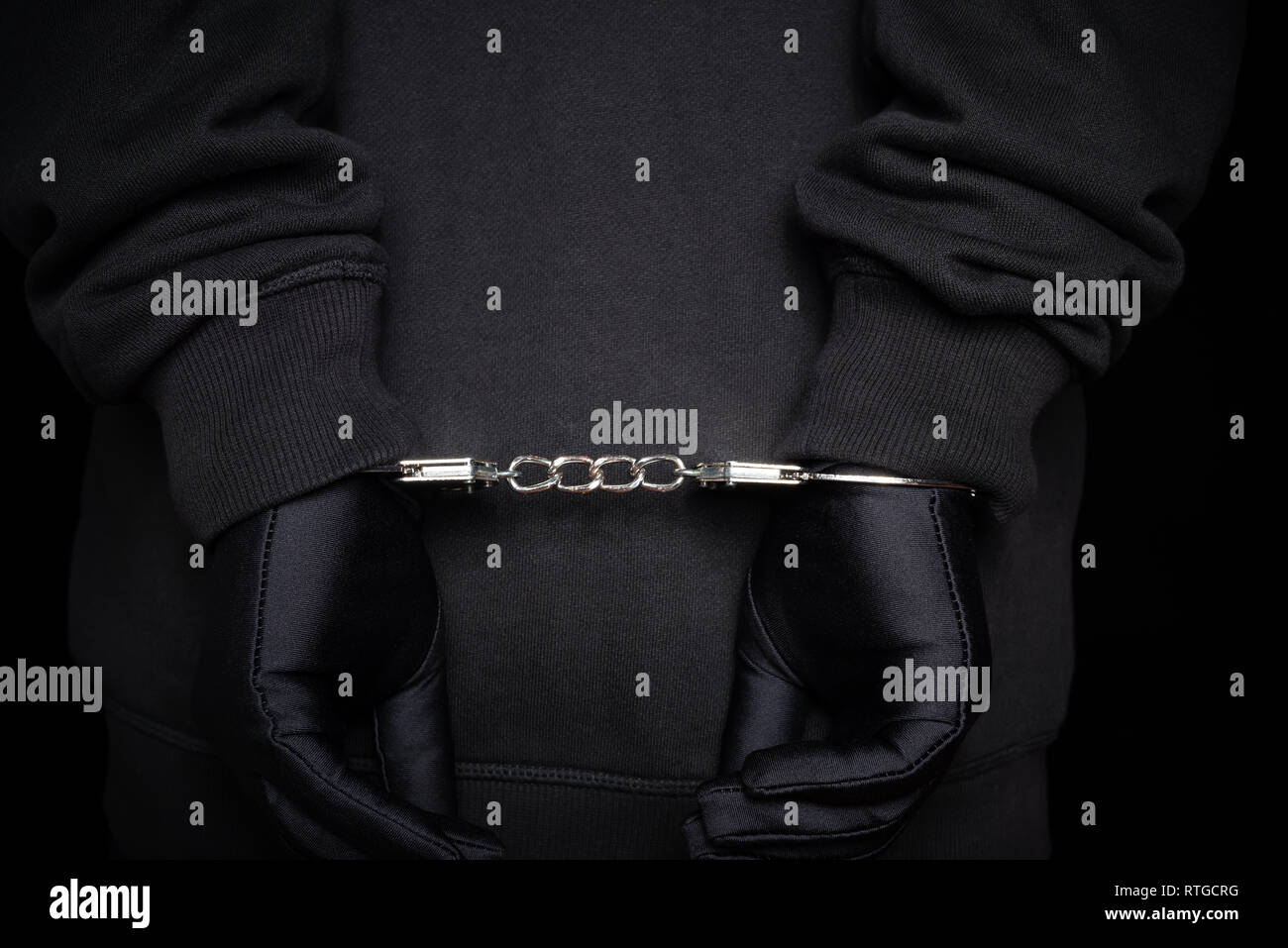 Robber in handcuffs hi-res stock photography and images - Alamy