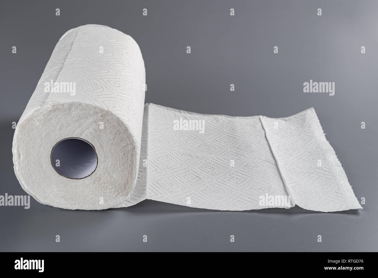 side view paper roll for kitchen on grey background Stock Photo - Alamy