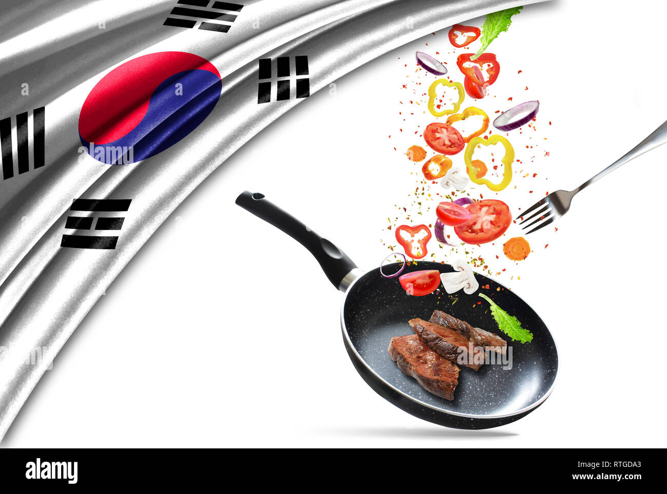 Frying pan with falling vegetables and meat, isolated. On the ...