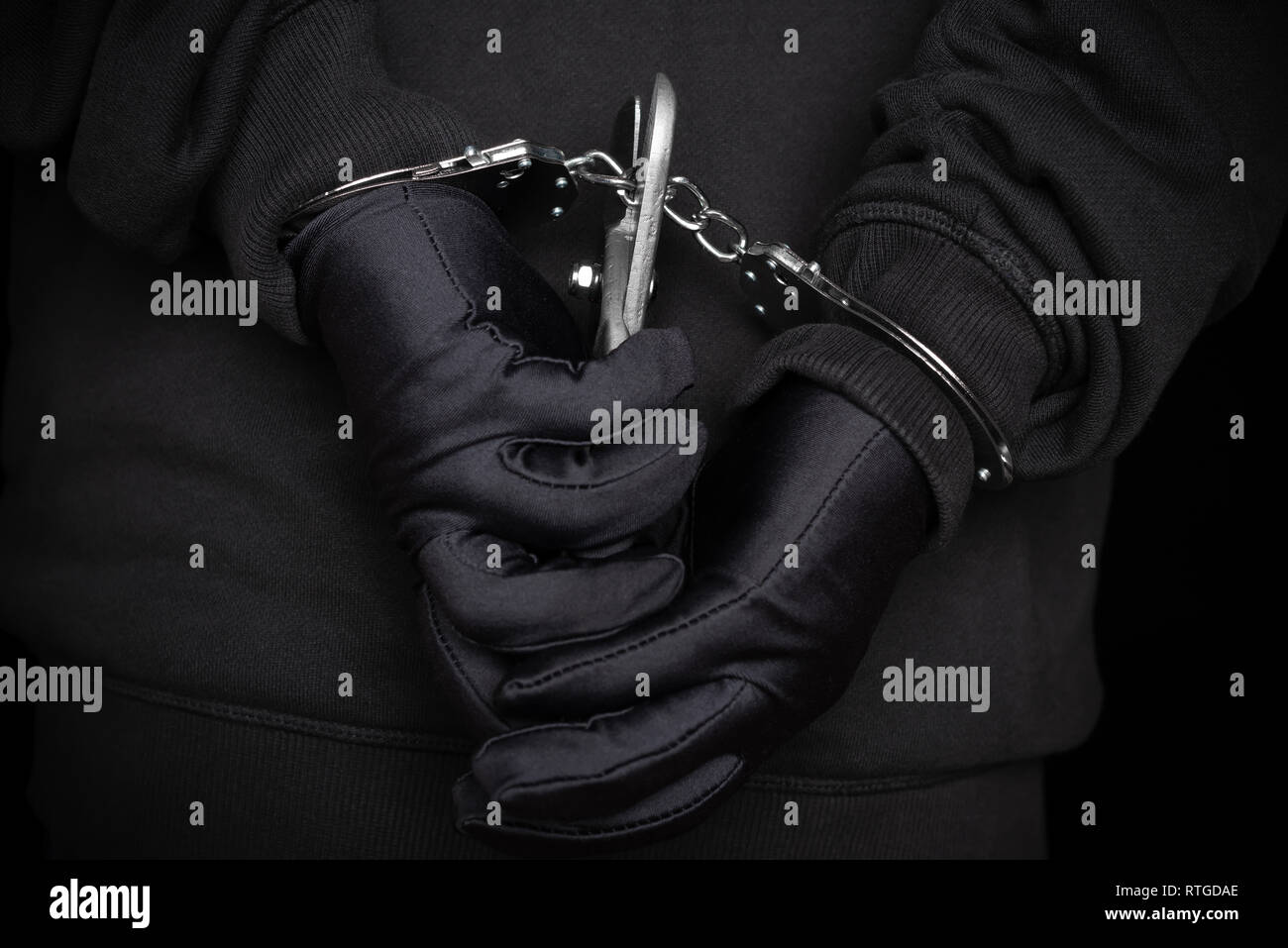 arrested man trying to cut the handcuffs with a cutter on his back ...