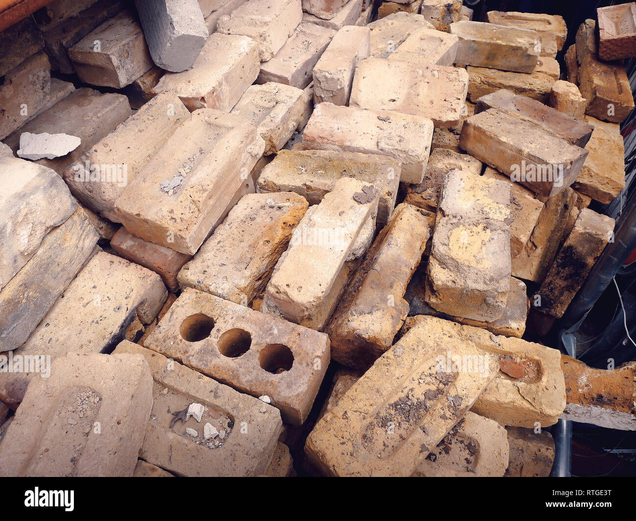 Pile of soft yellow bricks at a salvage yard in the UK Stock Photo - Alamy