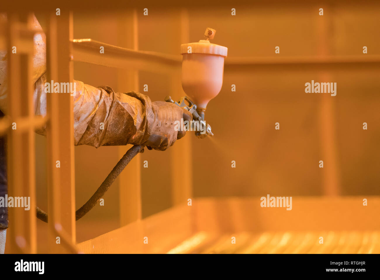Industrial concept. A man holding a spraying device Stock Photo - Alamy