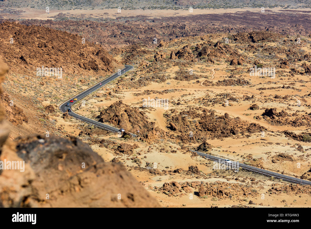 Road crossing spectacular lava shapped landscape in volcanic crater ...