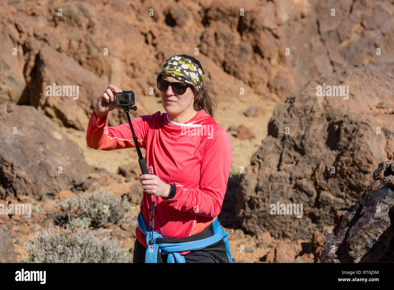 Adventure female vloger using action camera outdoor Stock Photo - Alamy