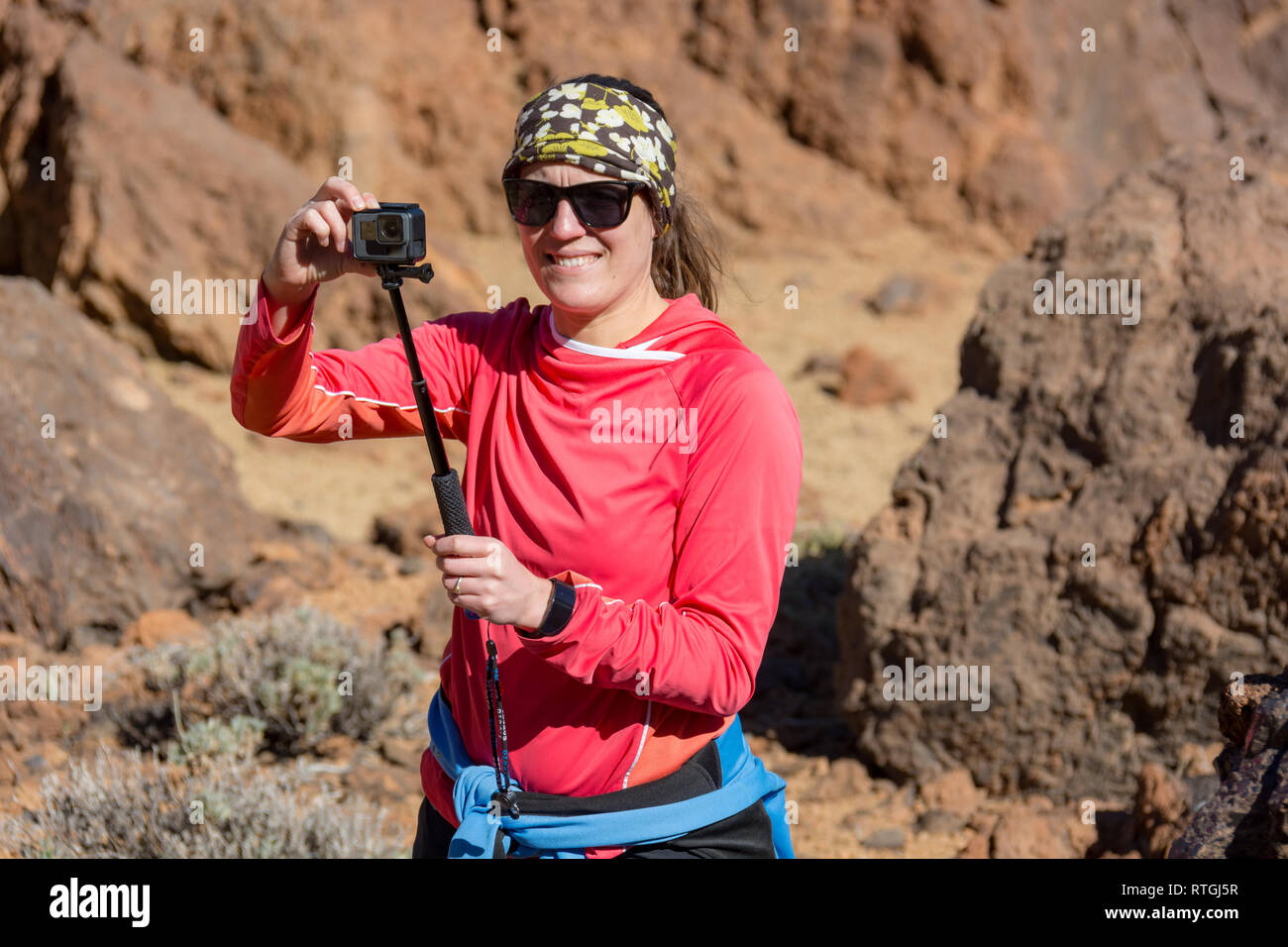 Adventure female vloger using action camera outdoor Stock Photo - Alamy