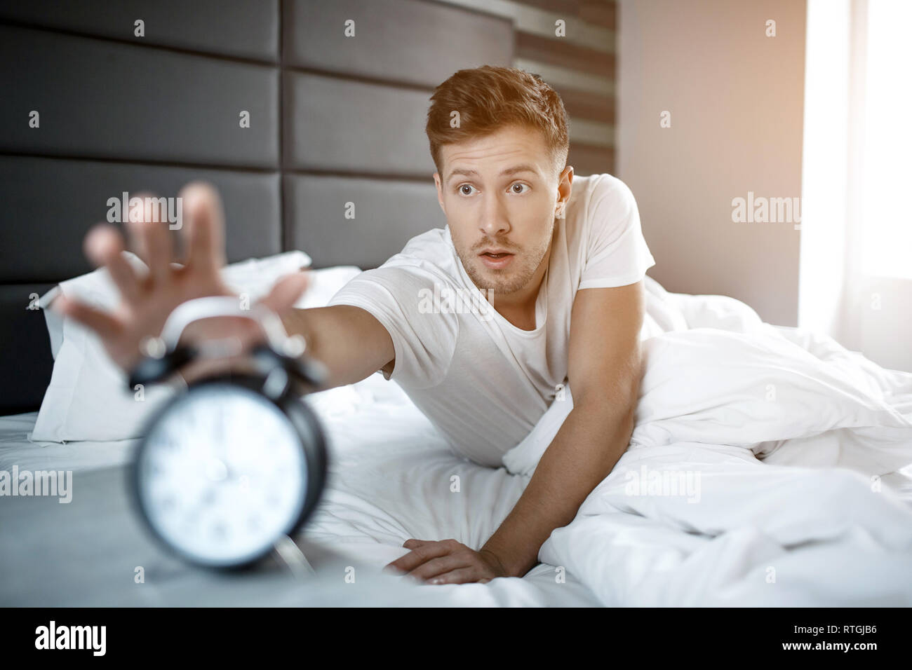 Frightened man lying in bed hi-res stock photography and images - Alamy