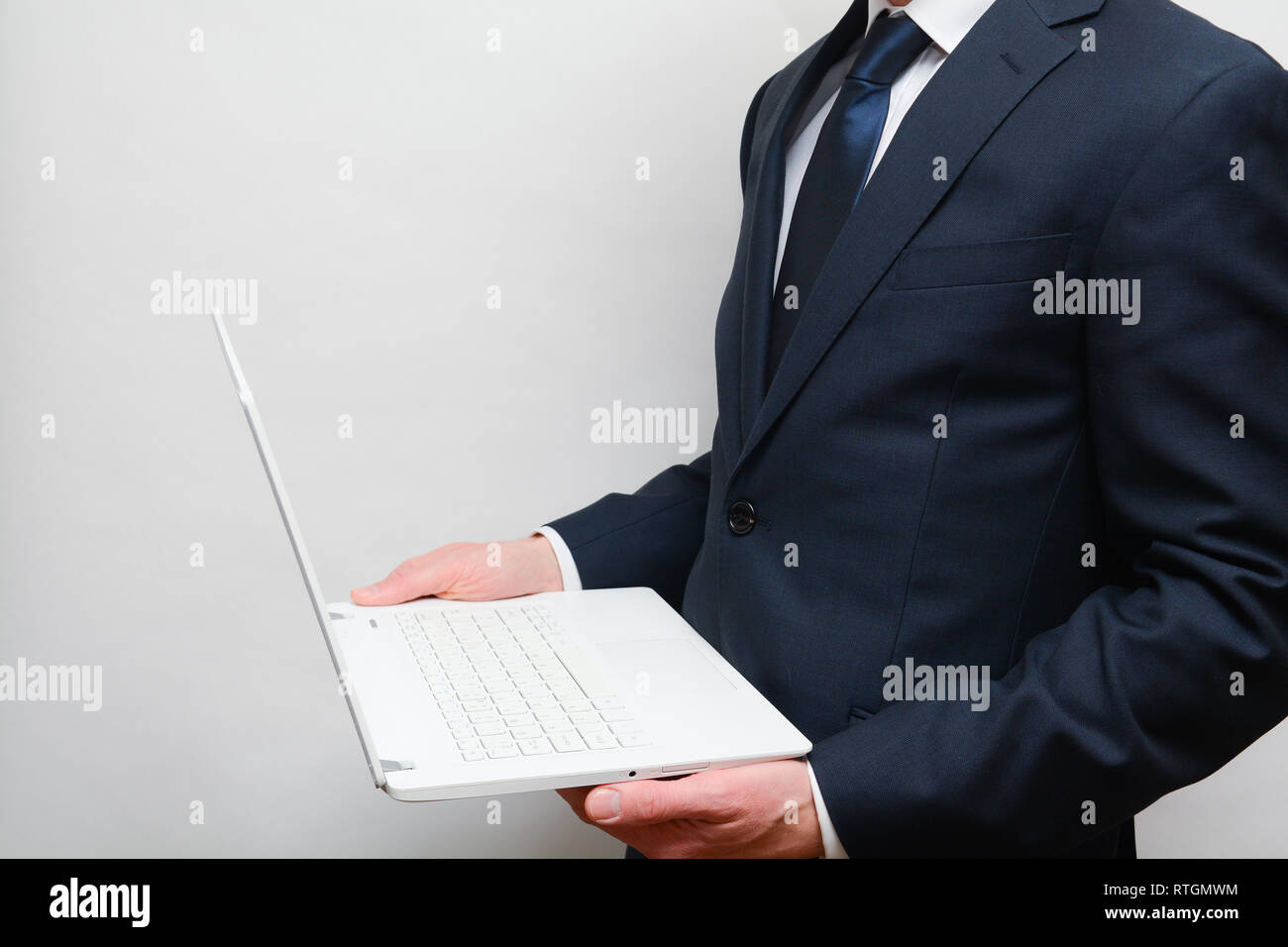 Man using laptop with blank white screen, shot from over shoulder Stock ...