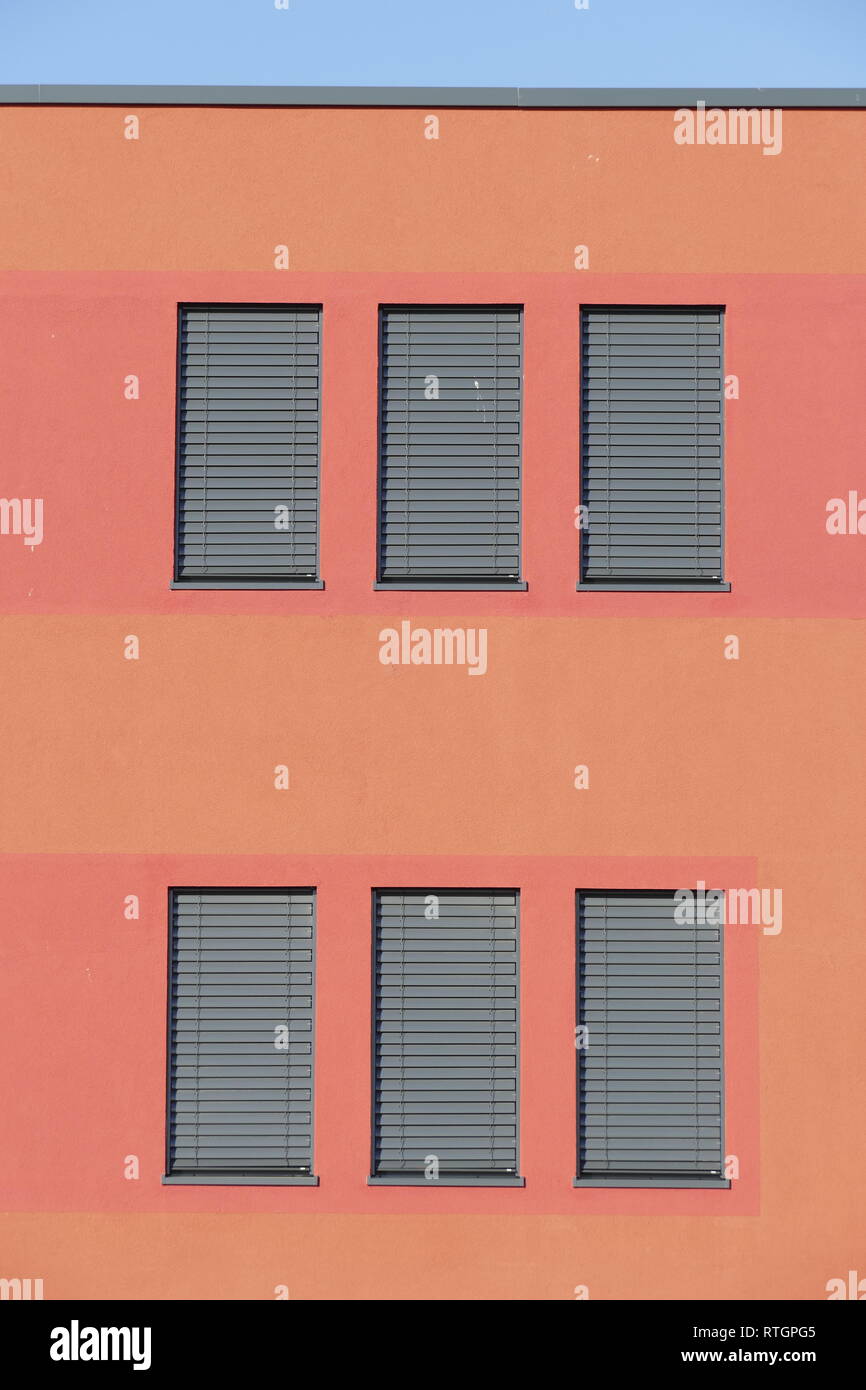 Window with dark shuttered blinds on a red house wall Stock Photo - Alamy