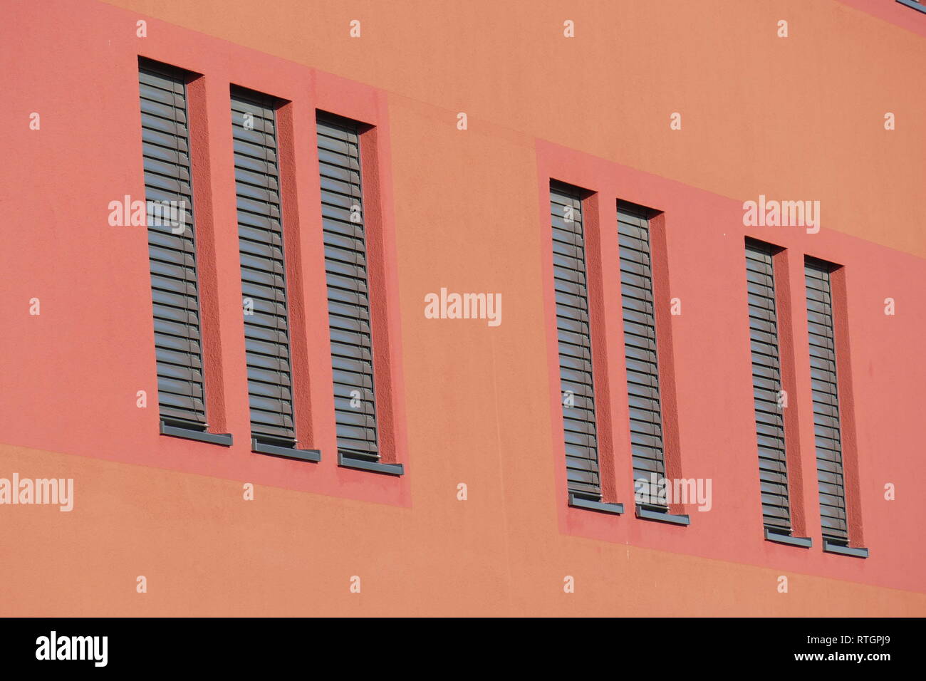 Window with dark shuttered blinds on a red house wall Stock Photo - Alamy