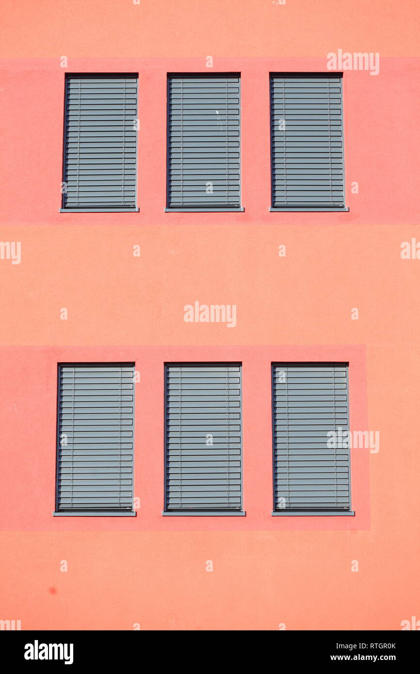 Window with dark shuttered blinds on a red house wall Stock Photo - Alamy