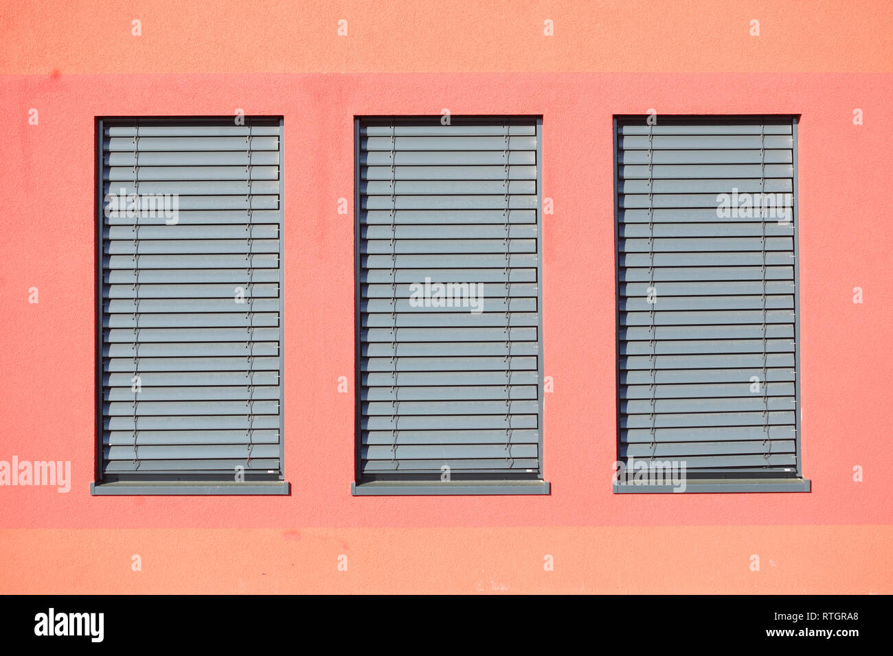 Window with dark shuttered blinds on a red house wall Stock Photo - Alamy