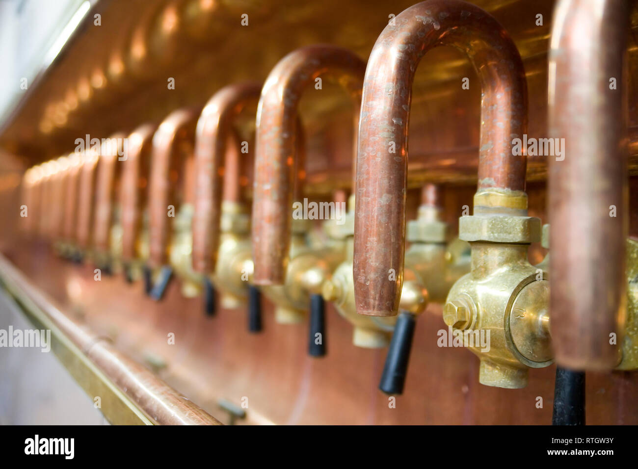 lots of taps in brewery for checking beer quality Stock Photo - Alamy