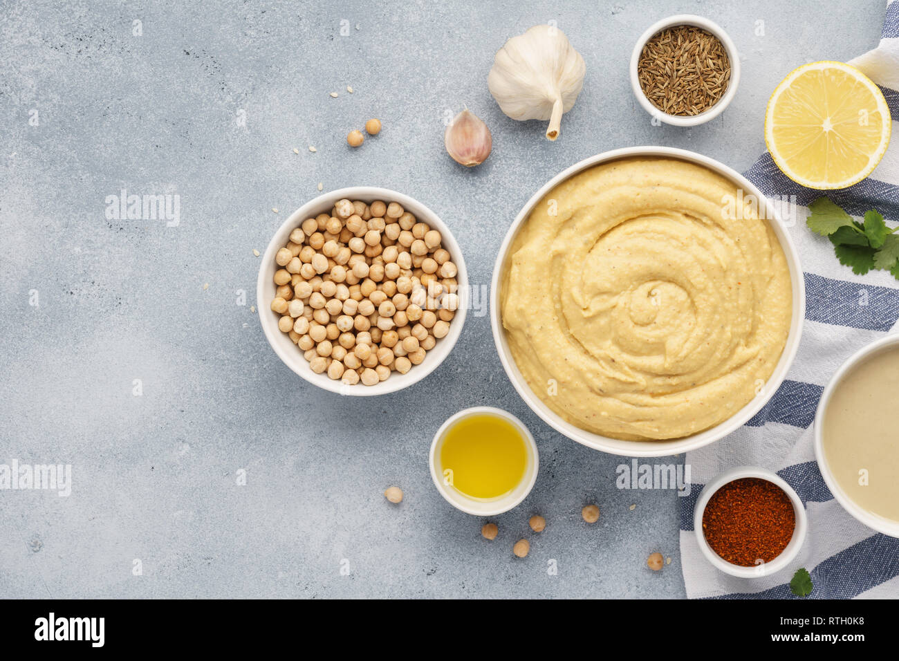 Bowl of hummus and ingredients - chickpea, tahini, olive oil, sesame ...