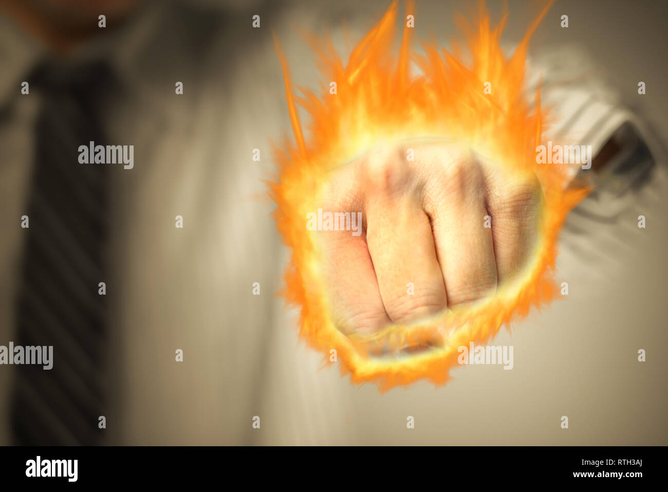 Business man punching with fist of fire Stock Photo - Alamy