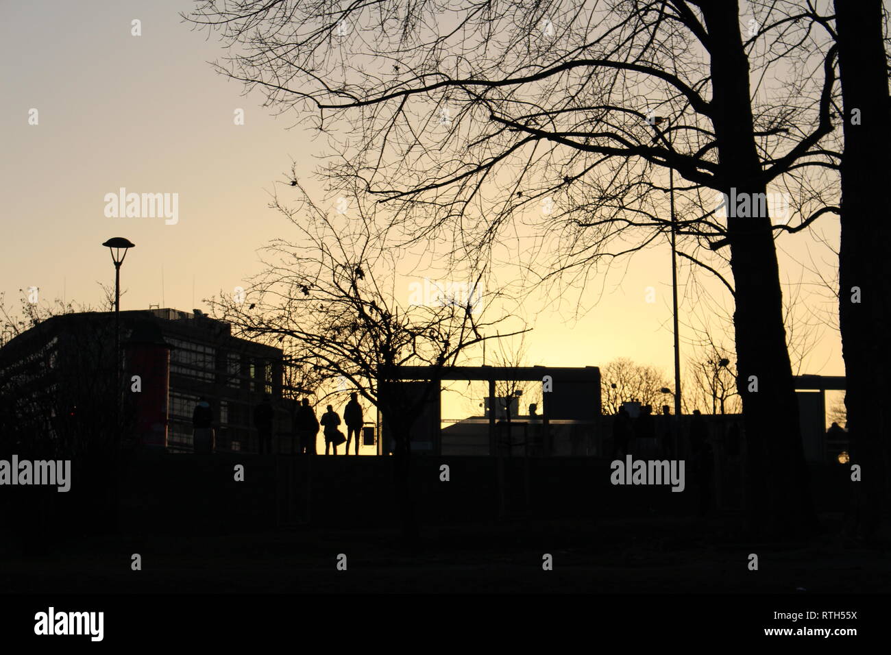 Shadows of people waiting at a bus stop in Kraków Stock Photo - Alamy
