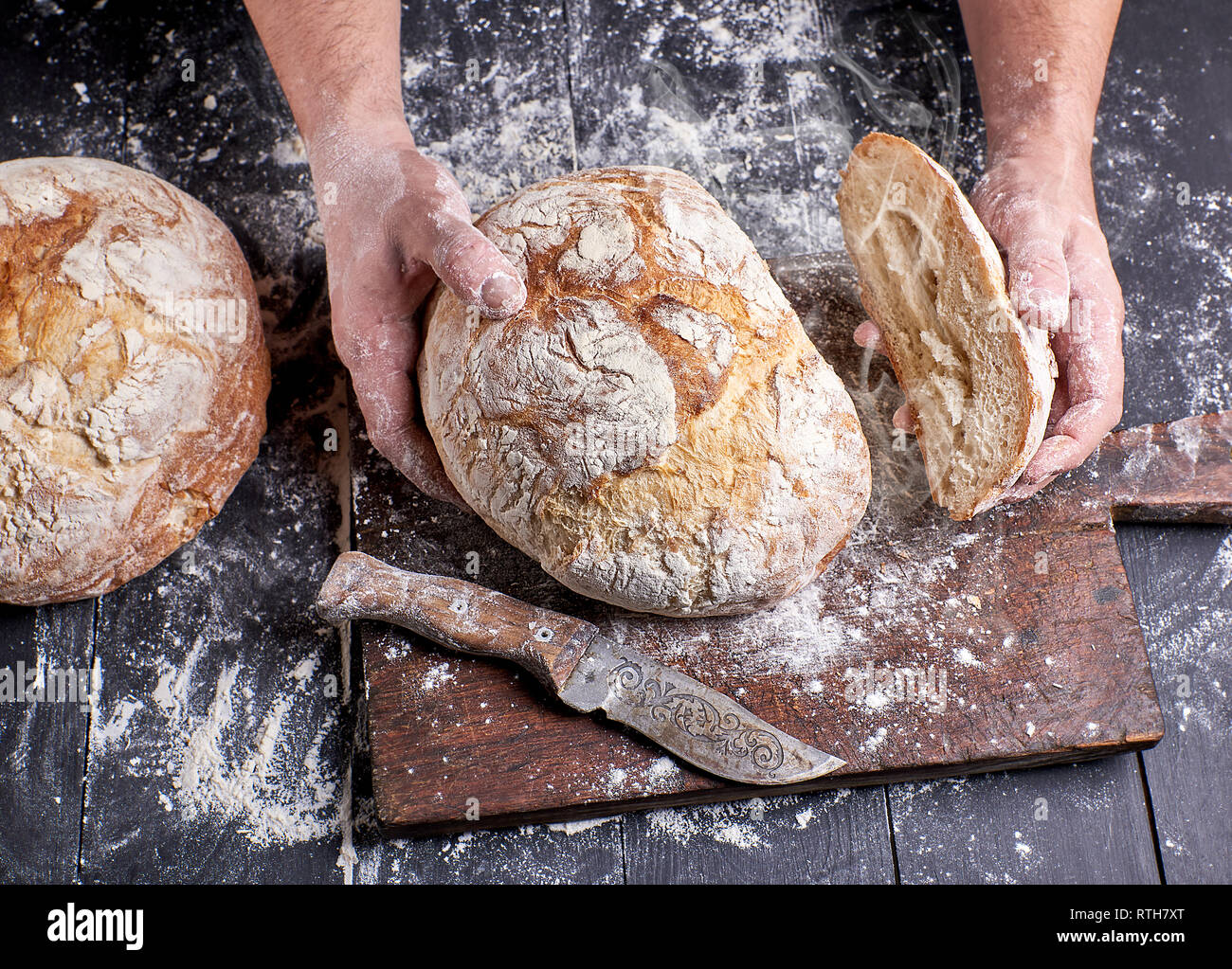 Holding a loaf of bread in his hands hi-res stock photography and ...
