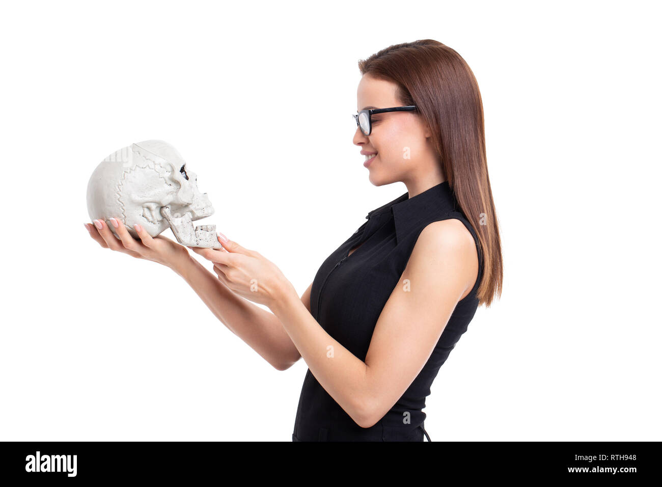 Young businesswoman talking with skull, profile view, isolated on white ...