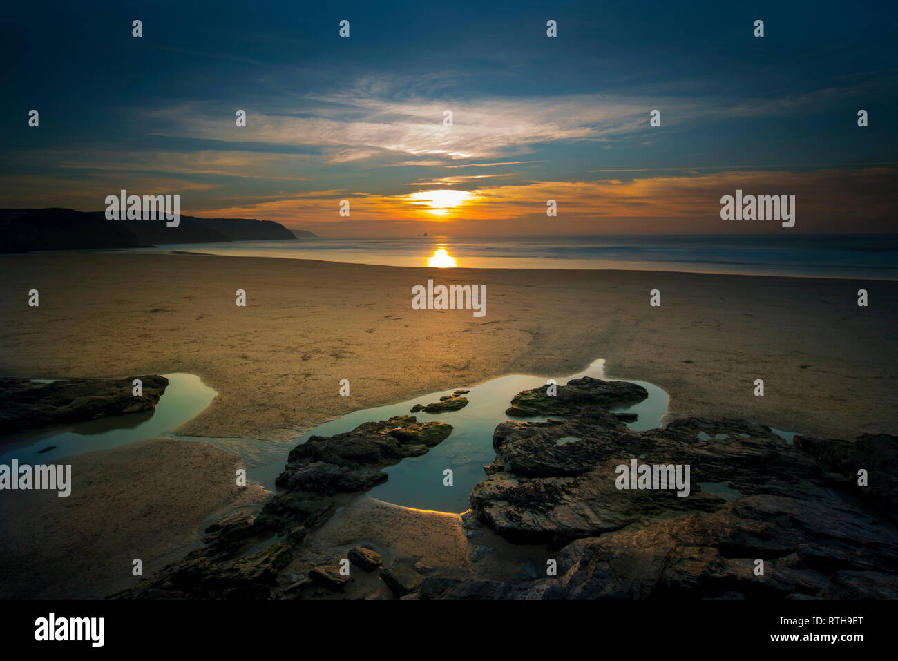 Gorgeous sunset over the rock pools and wide sandy beach at Perranporth ...