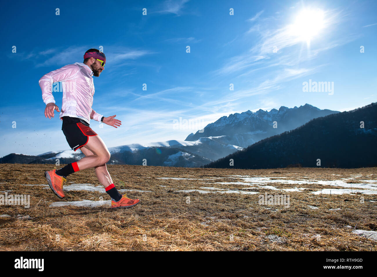 Mountain runner in downhill action on slippery ground Stock Photo - Alamy