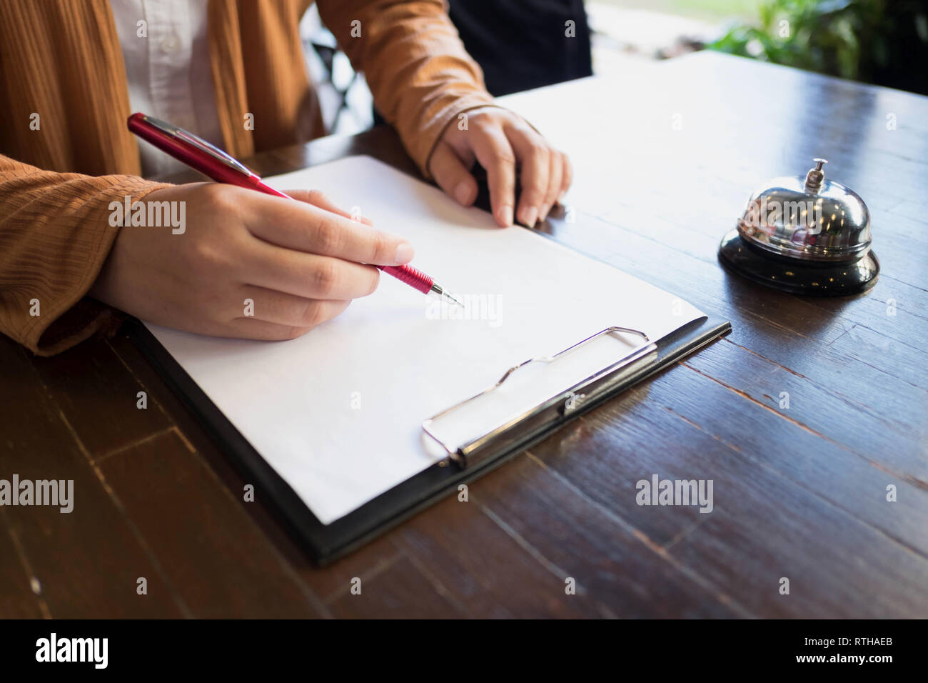 Woman filling form reception desk hi-res stock photography and images ...