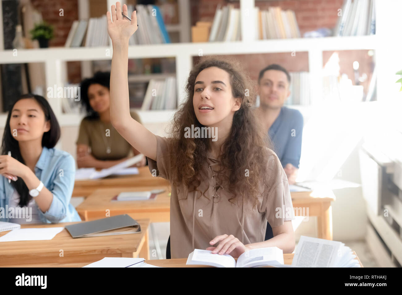 High school girl raising hand hi-res stock photography and images - Alamy